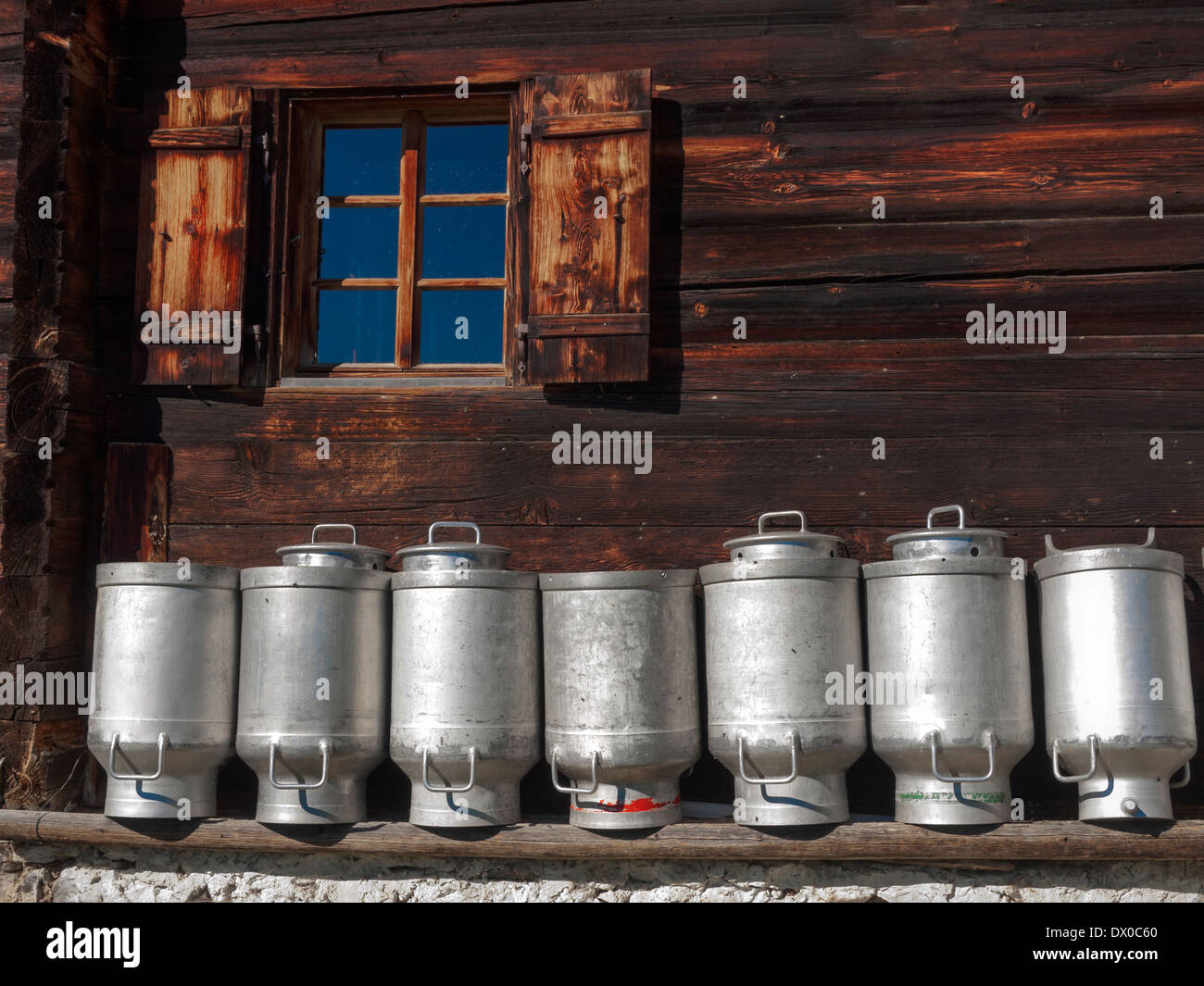 Empty milk cans in front of an alpine dairy in the Swiss mountains ...