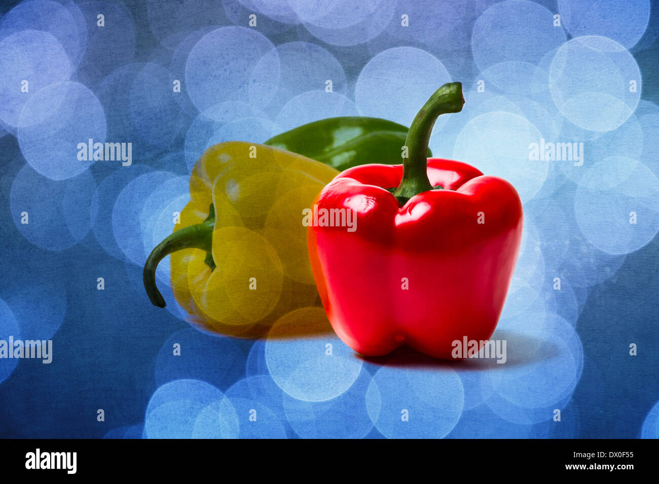 Three sweet peppers of red, yellow and green color. Red pepper is a ...