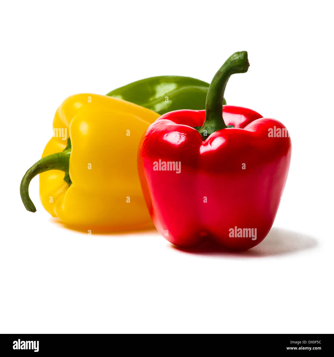 Three sweet peppers of red, yellow and green color. Red pepper is a ...