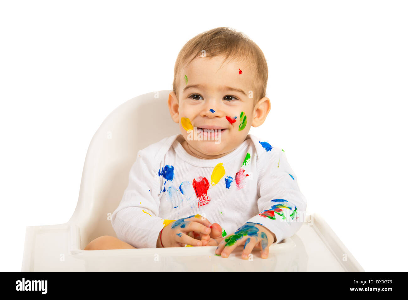 Happy painter baby at table looking away isolated on white background ...