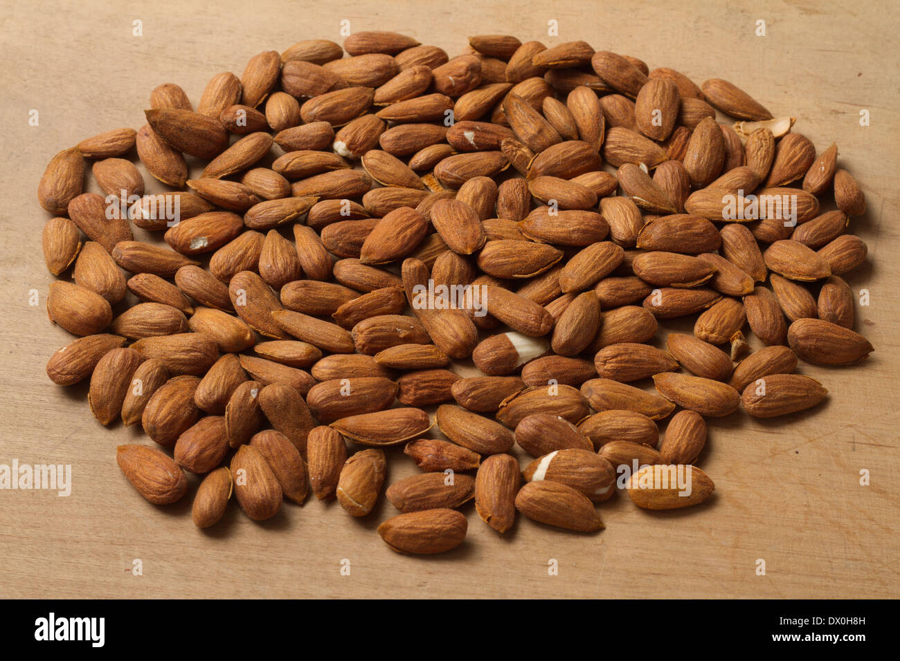 Almonds on wooden background Stock Photo - Alamy