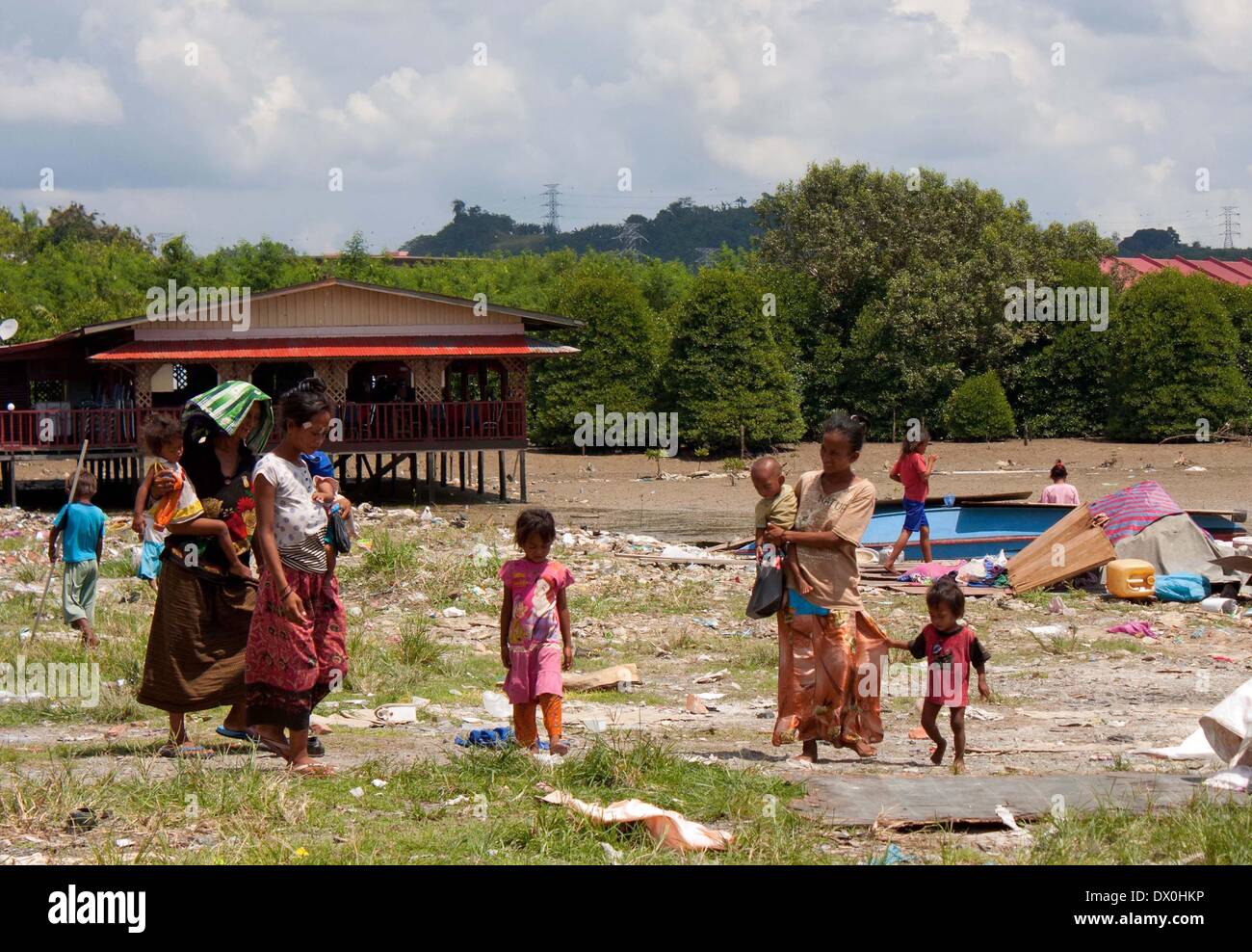 Bajau people walk along the coast in Lahad Datu, Sabah, Malaysia, 24 ...