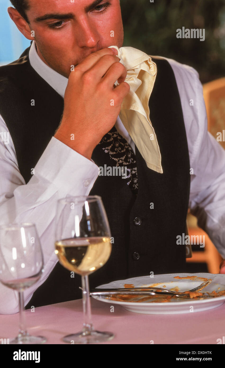Man wipes his mouth with a napkin after eating Stock Photo - Alamy