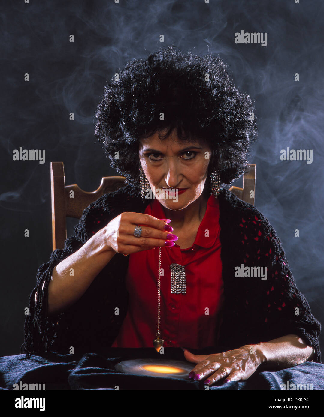 Fortune-teller holding a pendulum Stock Photo - Alamy