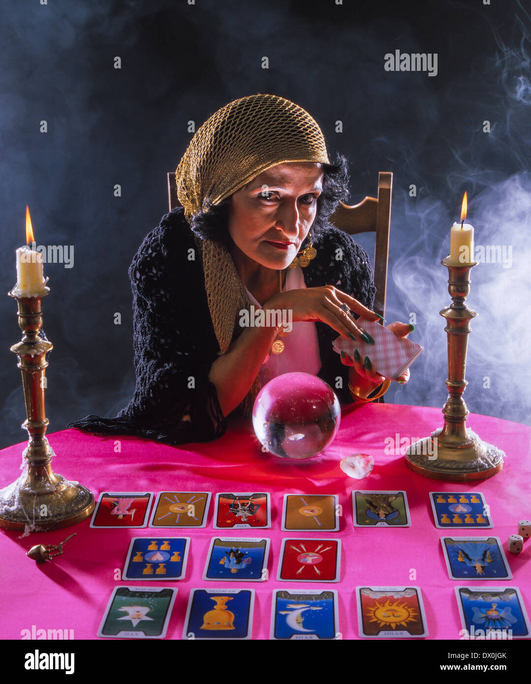Fortune teller looking into a crystal ball and puts the cards Stock ...