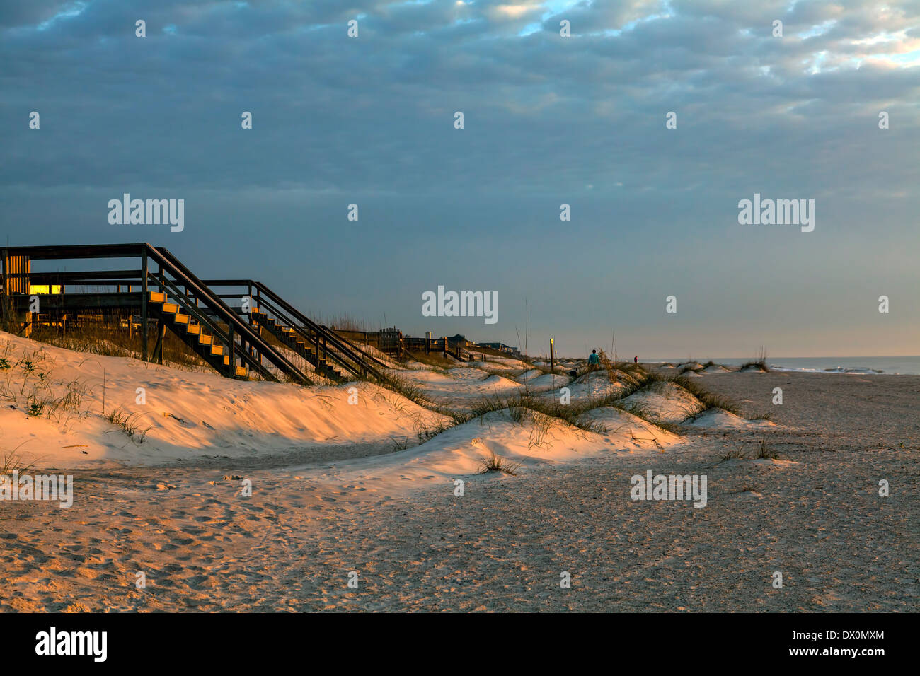 Sunrise illuminates wood framed beach crossovers and residences along ...