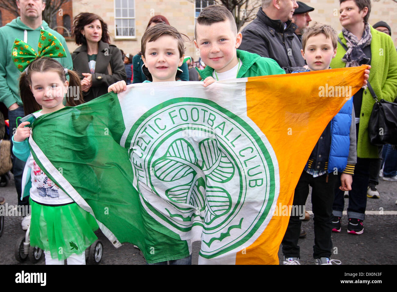 Belfast UK, 16th March, 2014. Children hold up a Irish Tri-Colour with ...