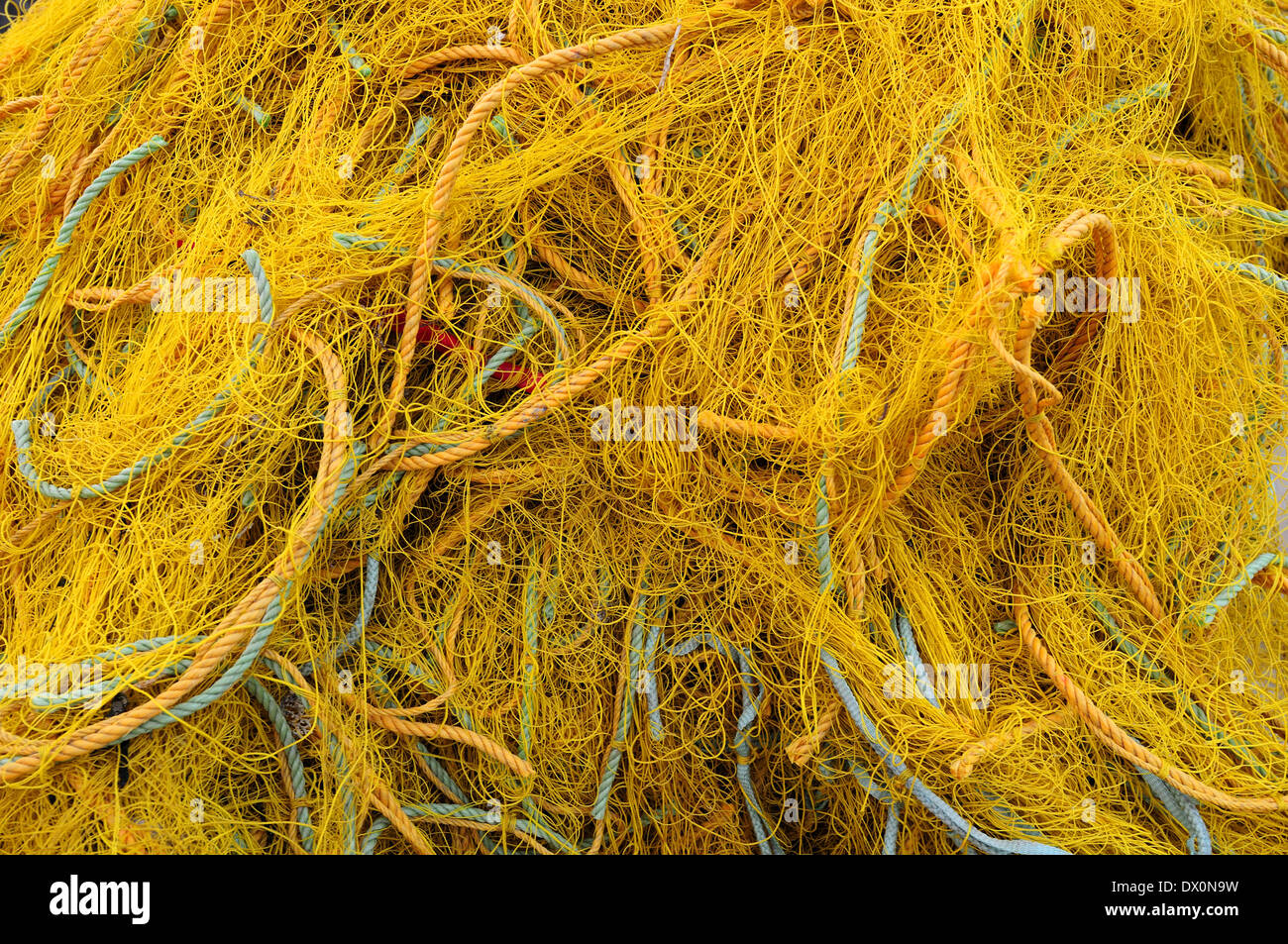Tangled fishing nets dry in the sun Stock Photo - Alamy