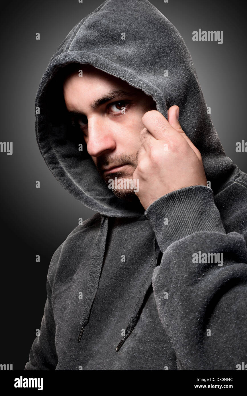 Young angry gangster with the hood on his head Stock Photo - Alamy