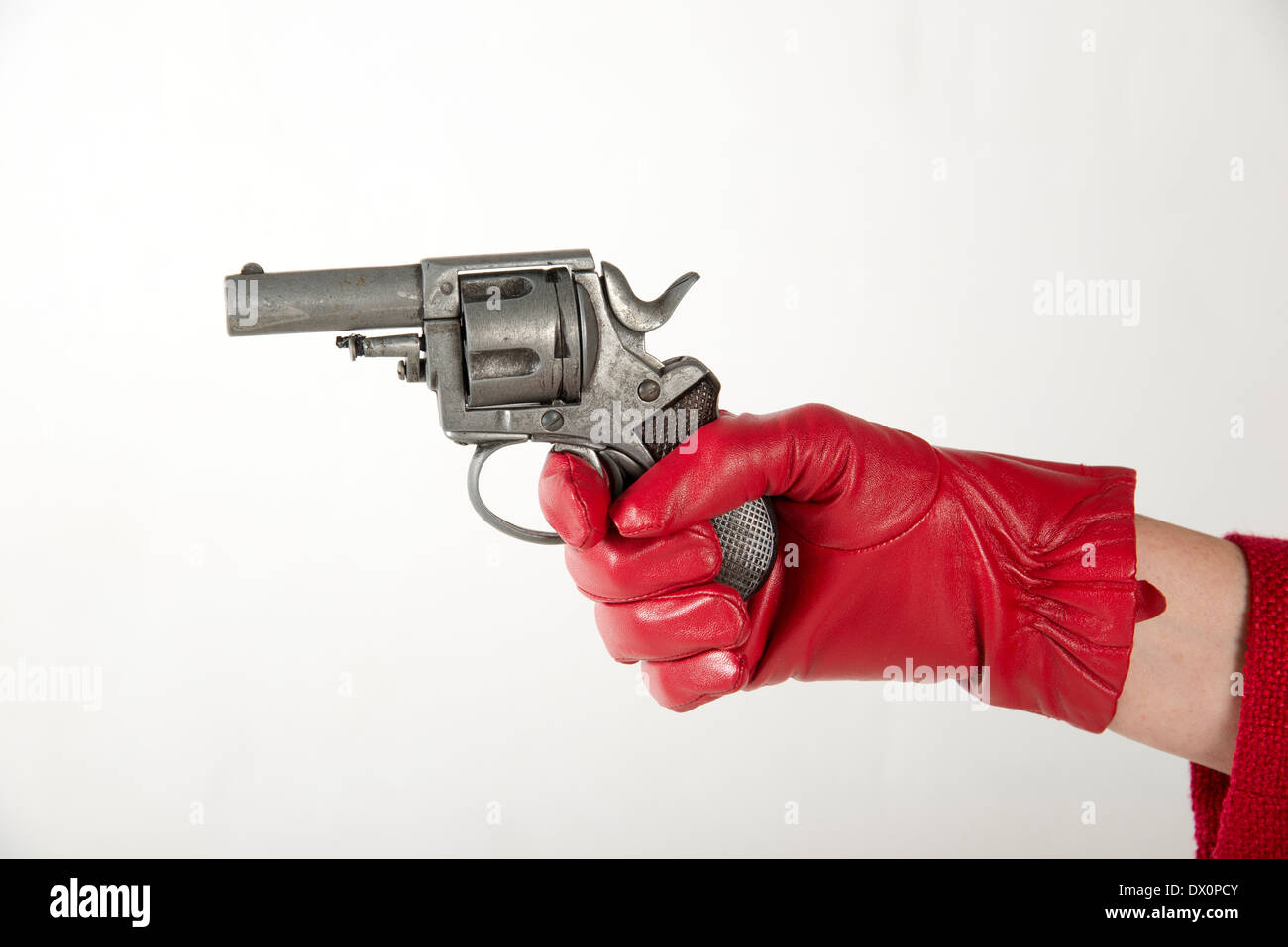 Woman wearing red leather glove holding a gun. Cocking a revolver Stock ...