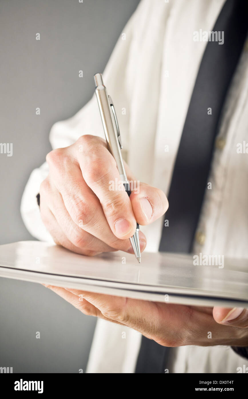 Businessman writing notes or signing document. Close up image with ...