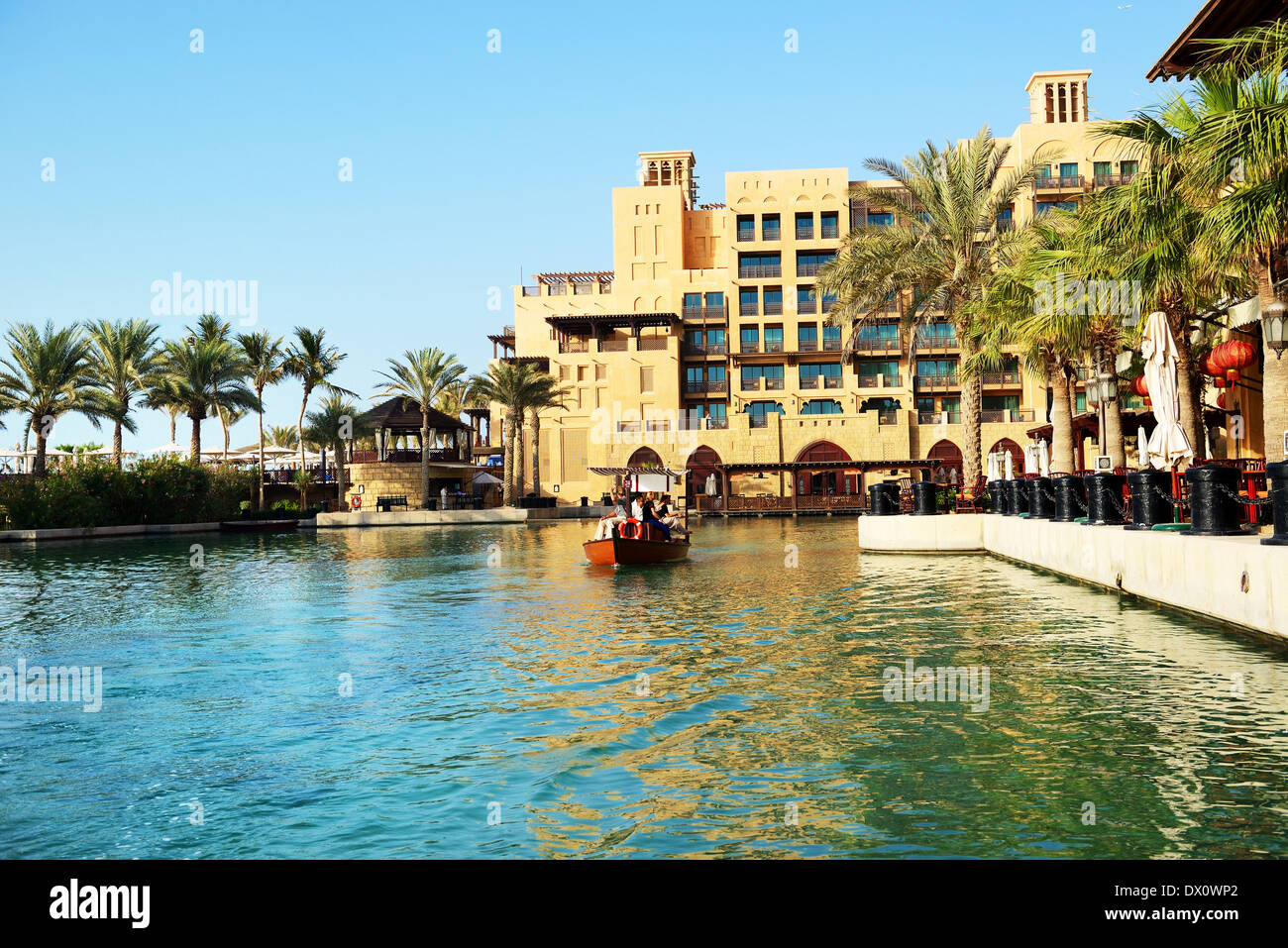 View of the Souk Madinat Jumeirah and tourists swimming on abra boat ...