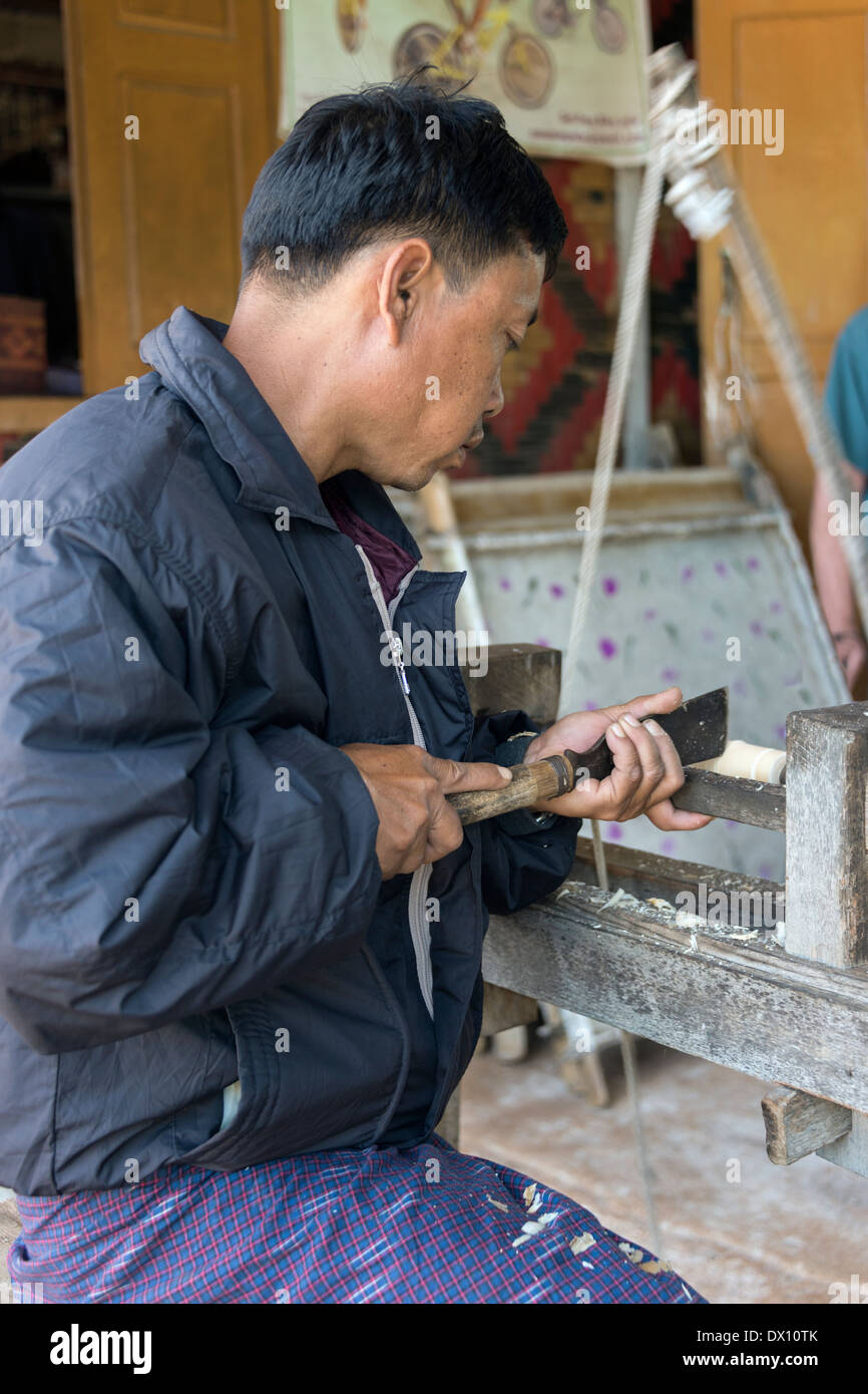 Man working a foot lathe to shape an umbrella handle, He Ho, Shan ...