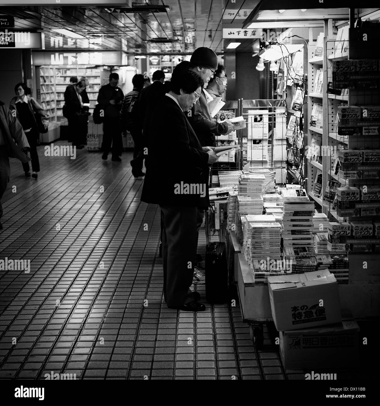 Men Reading In Underground Shinjuku, Tokyo, Japan Stock Photo - Alamy