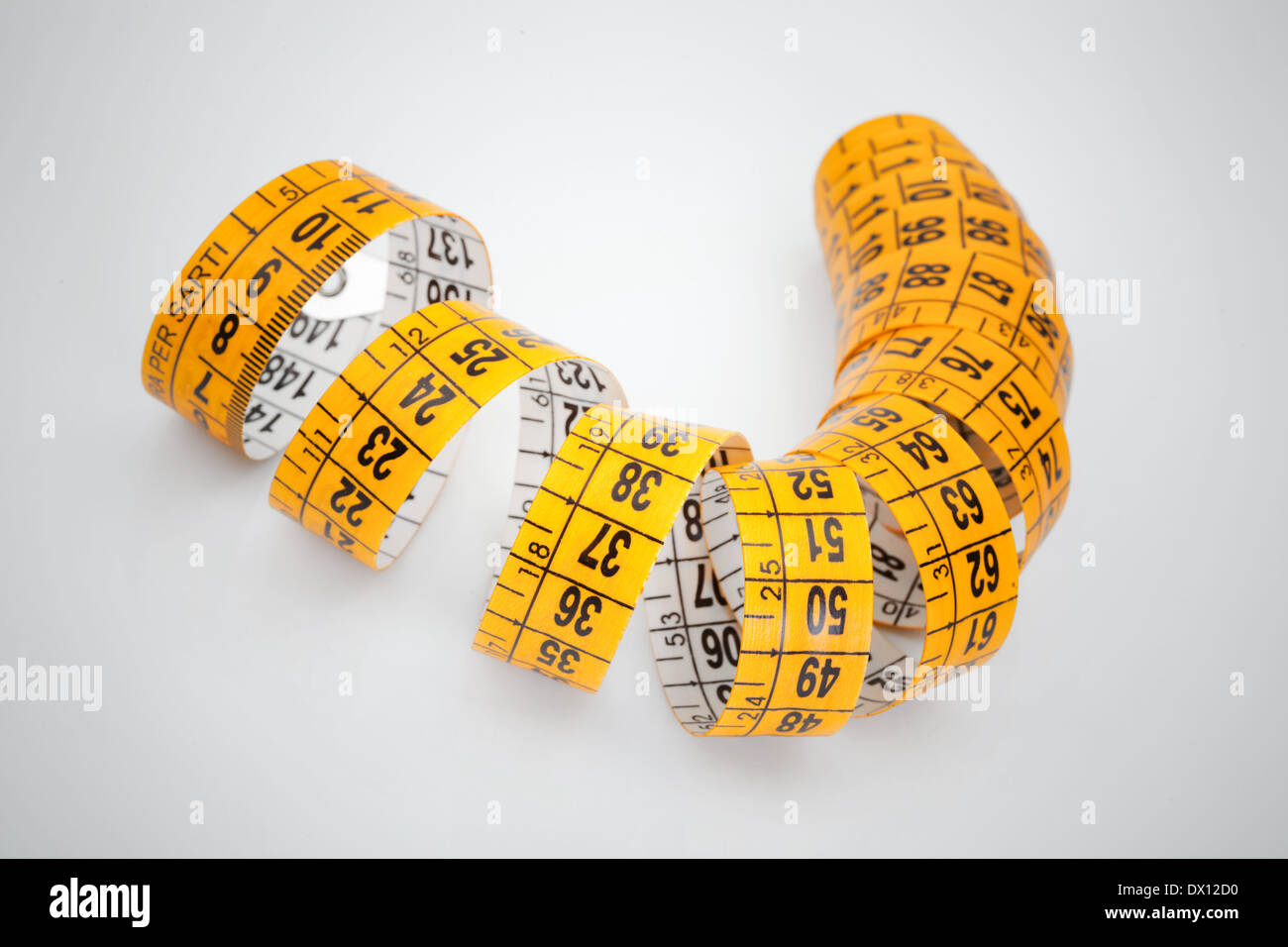 Yellow measuring tape isolated on white background Stock Photo - Alamy