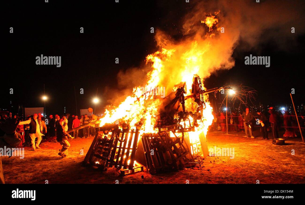 Kathmandu, Nepal. 16th Mar, 2014. People burn the ceremonial pole "Chir ...