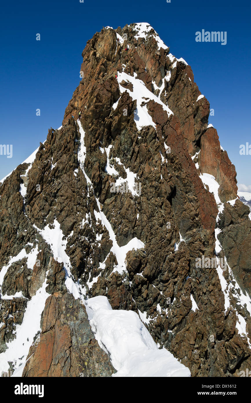Tiny mountain climbers on the Breithorn mountain wall, Monte Rosa ...