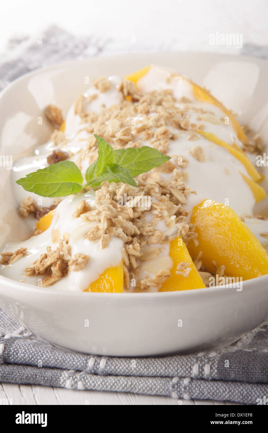 yogurt with mango piece, mint and cereals Stock Photo - Alamy