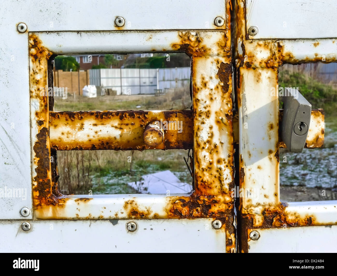 Gate lock at building site Stock Photo - Alamy