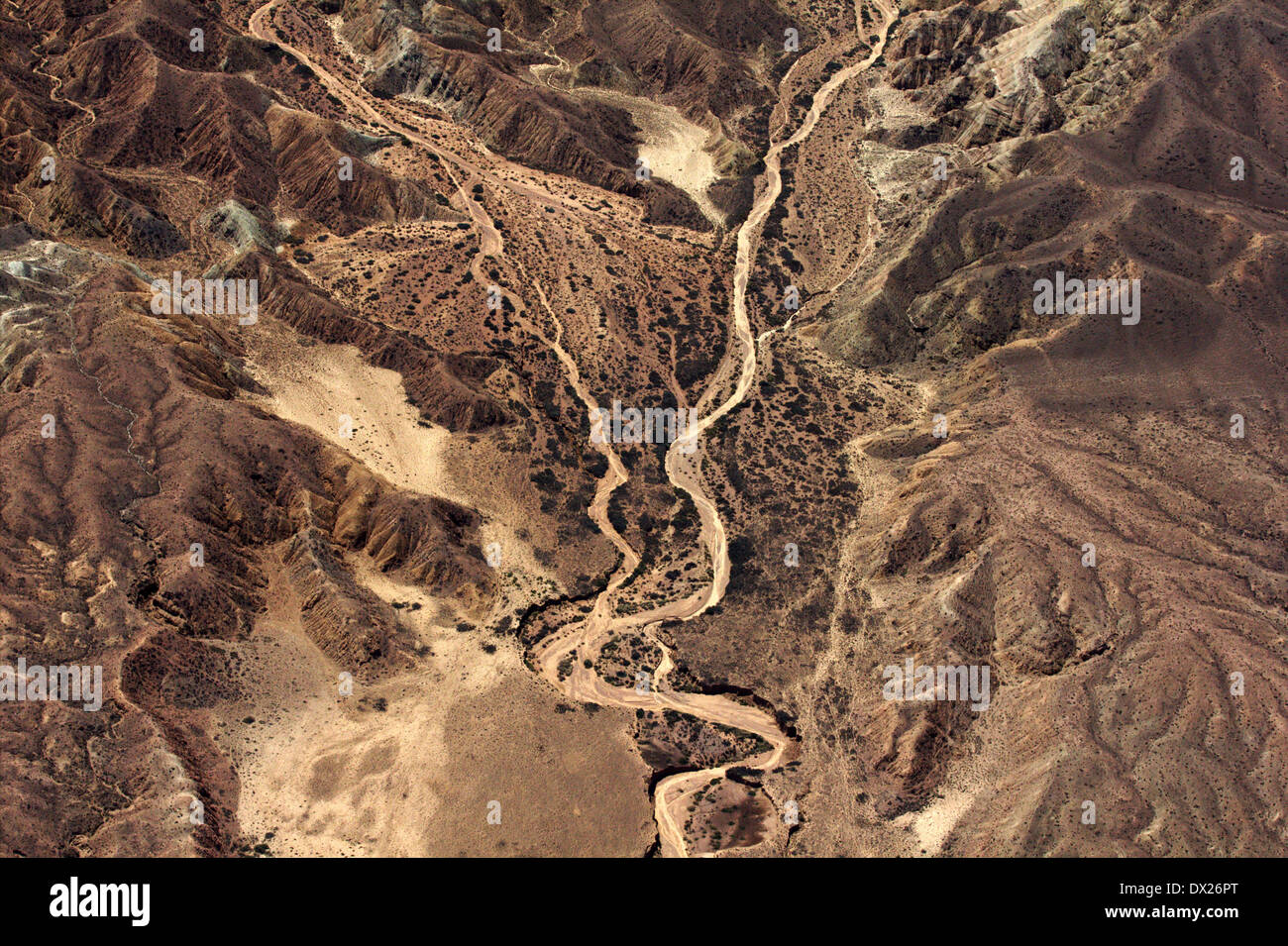 Dry river crossing badlands at southern coast of Issyk-Kul lake ...