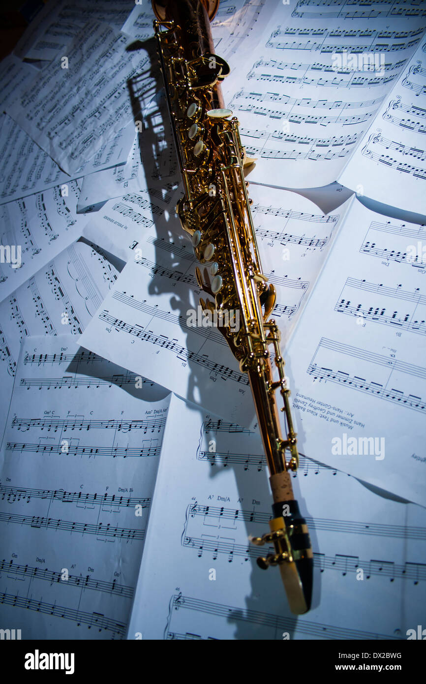 A soprano saxophone lying on sheet music Stock Photo - Alamy