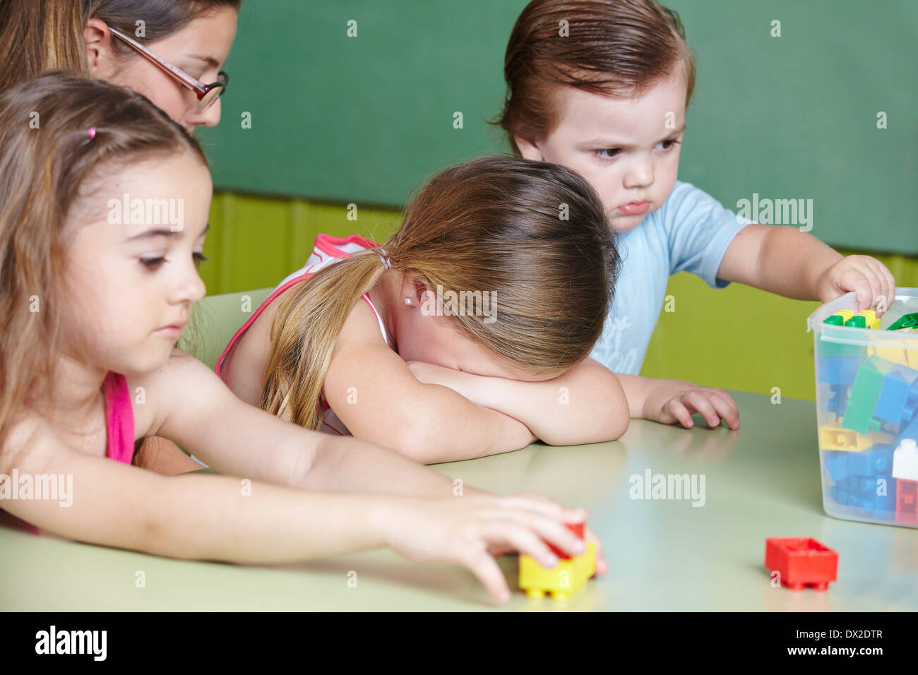Children playing with basketball and getting comfort from nursery ...
