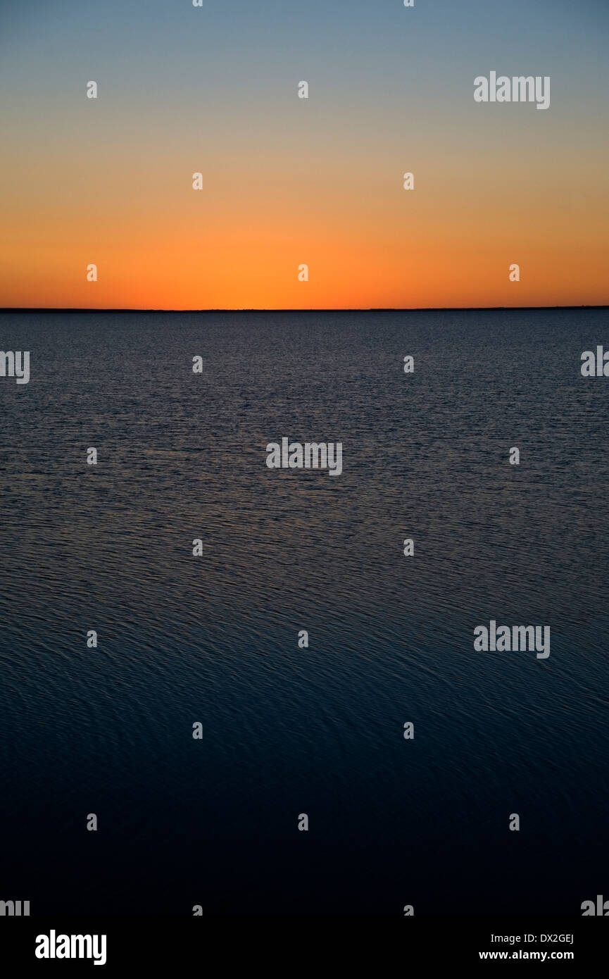 sunset over water Stock Photo - Alamy