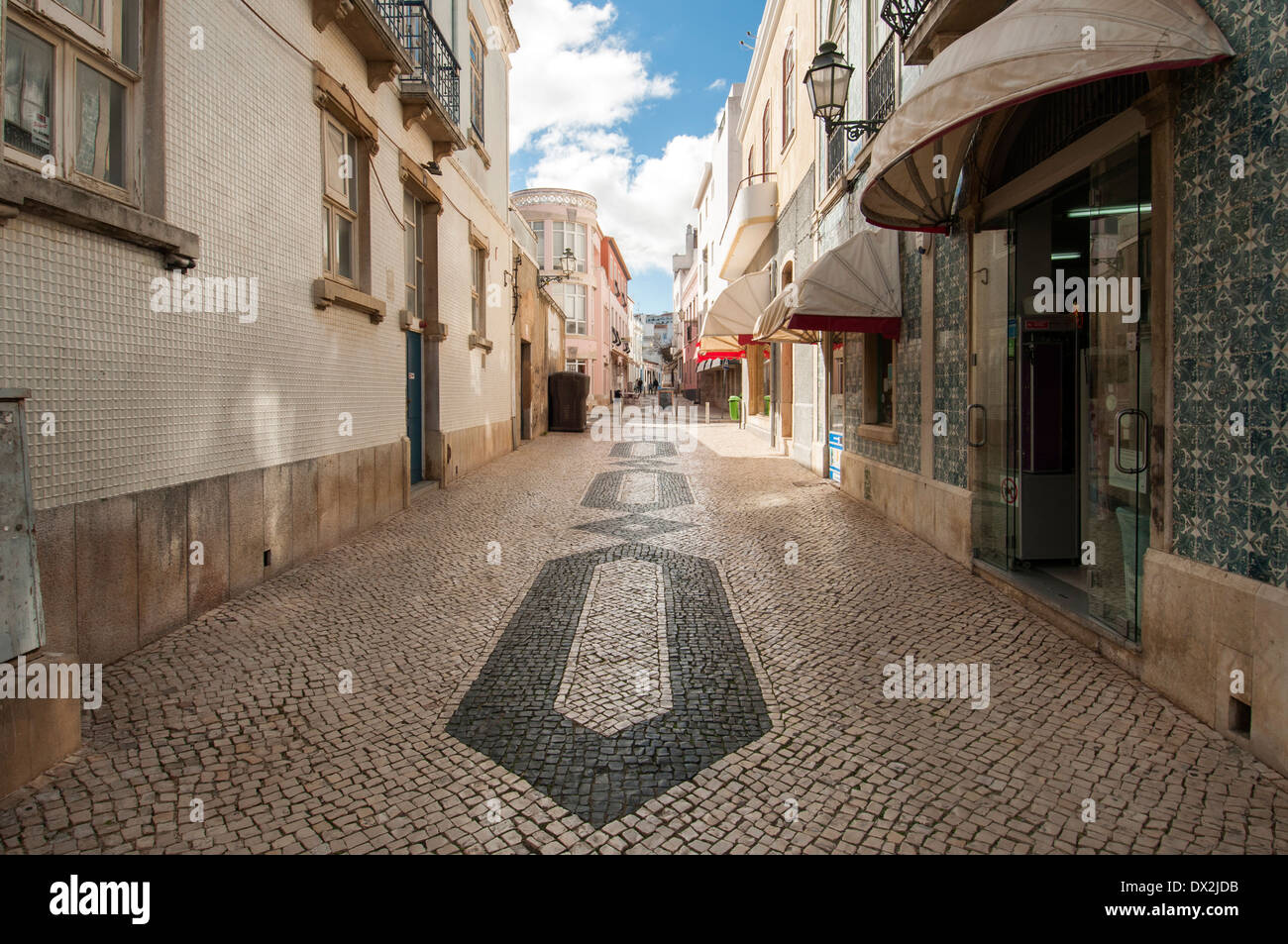 Traditional tiled building and mosaic tiled street in the old town of ...