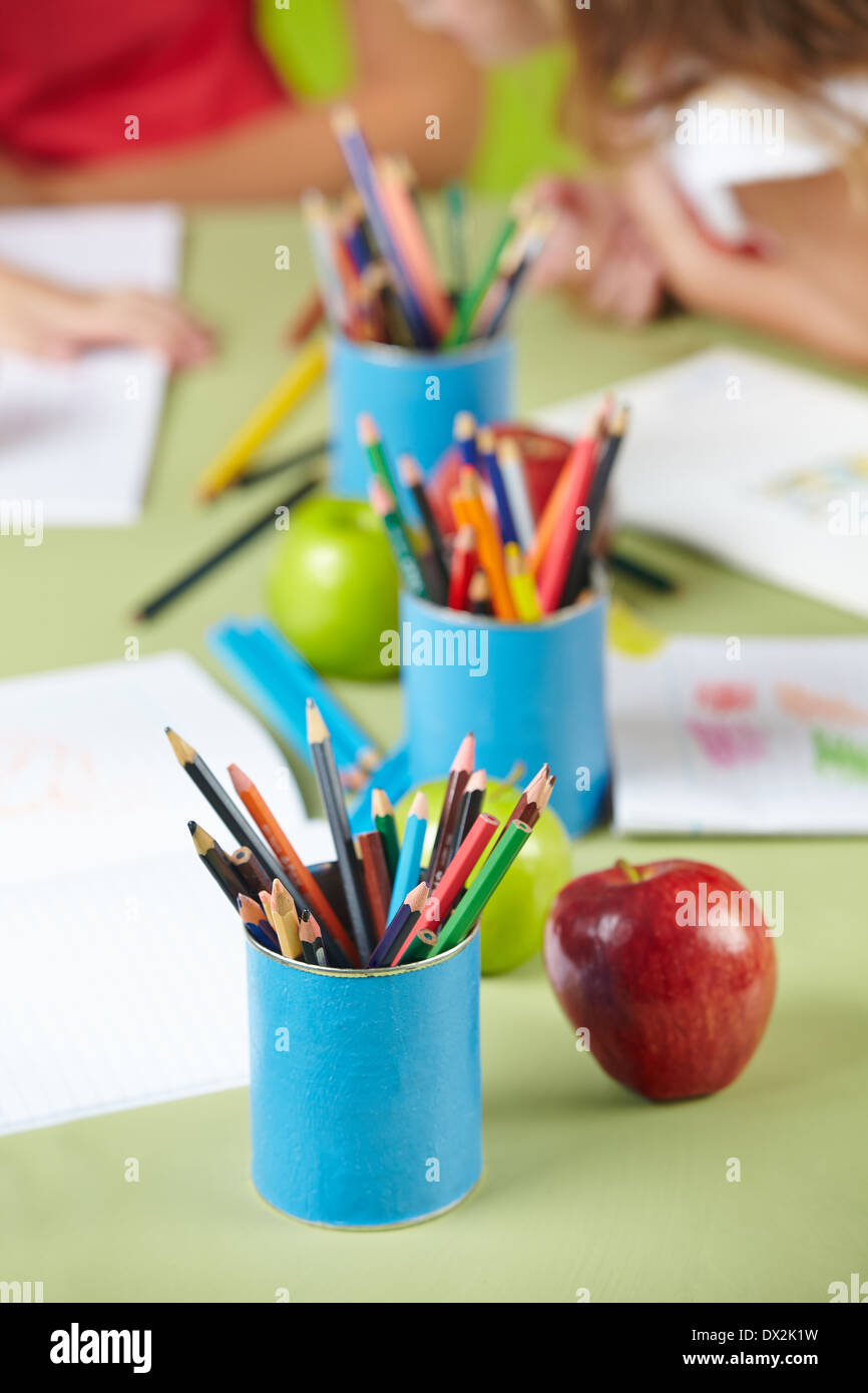 Kids drawing with crayons at a table hi-res stock photography and ...