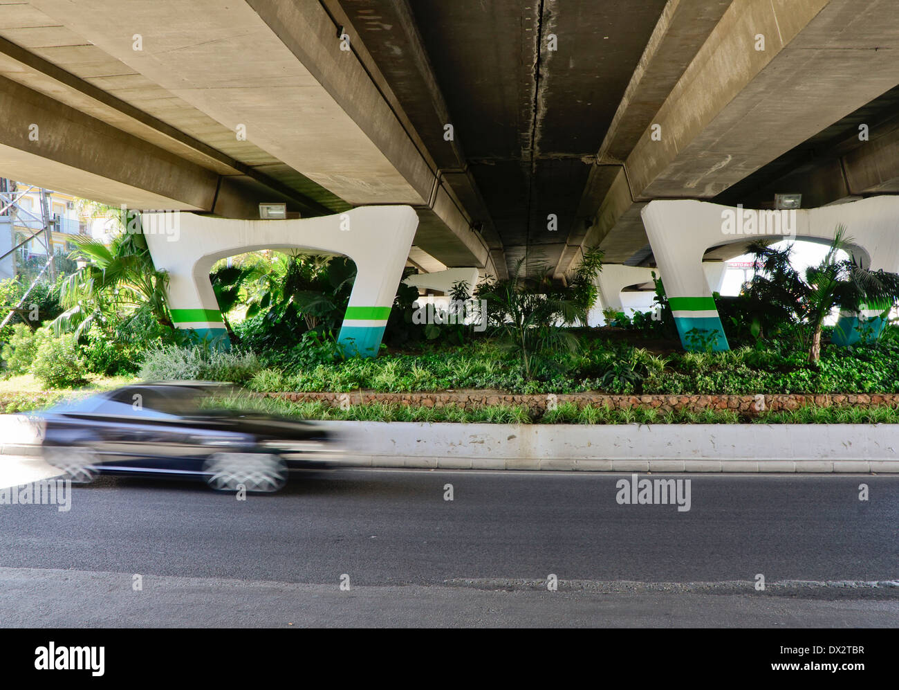 Roundabout under a highway bridge with vegetation, Spain Stock Photo ...