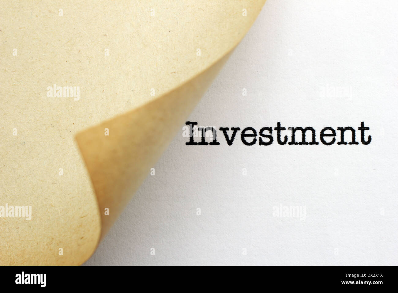 Investment text behind paper Stock Photo - Alamy