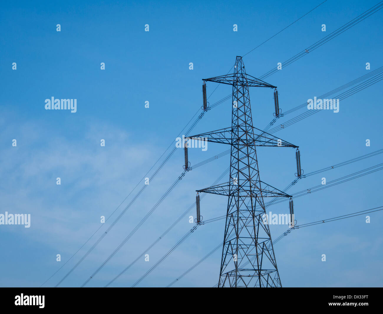 Electricity pylon and overhead power cables against blue sky Stock ...