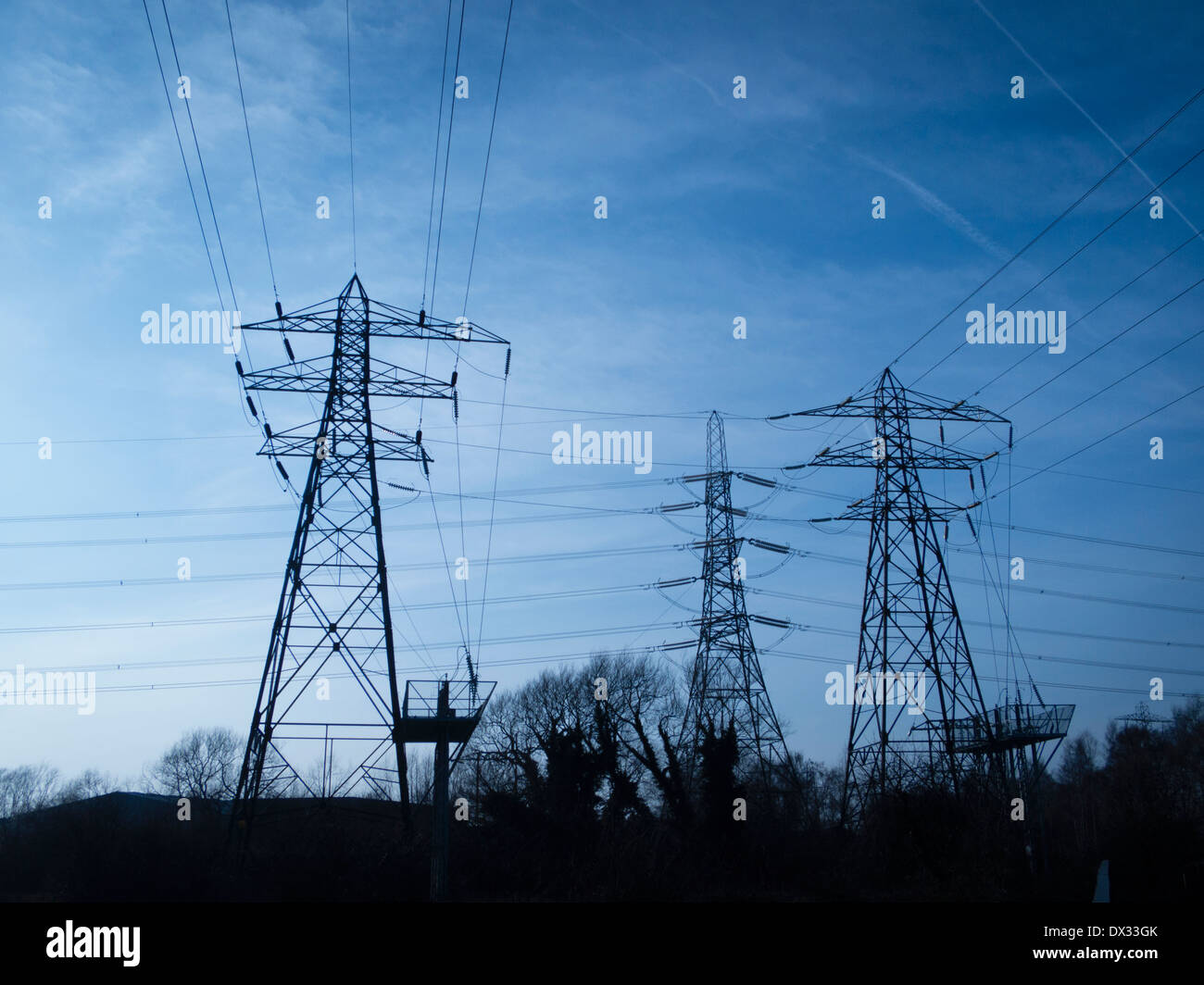Electricity pylons against blue sky Stock Photo - Alamy