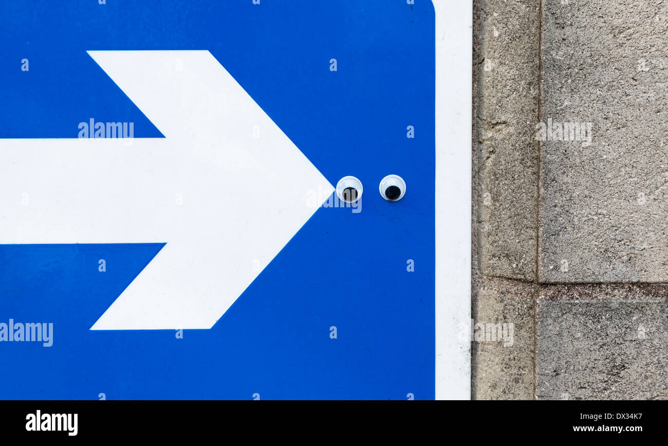 Arrow sign with two eyes Stock Photo - Alamy