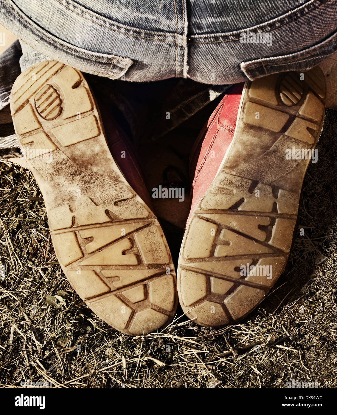 A girl sitting on her feet on the picnic back view Stock Photo - Alamy
