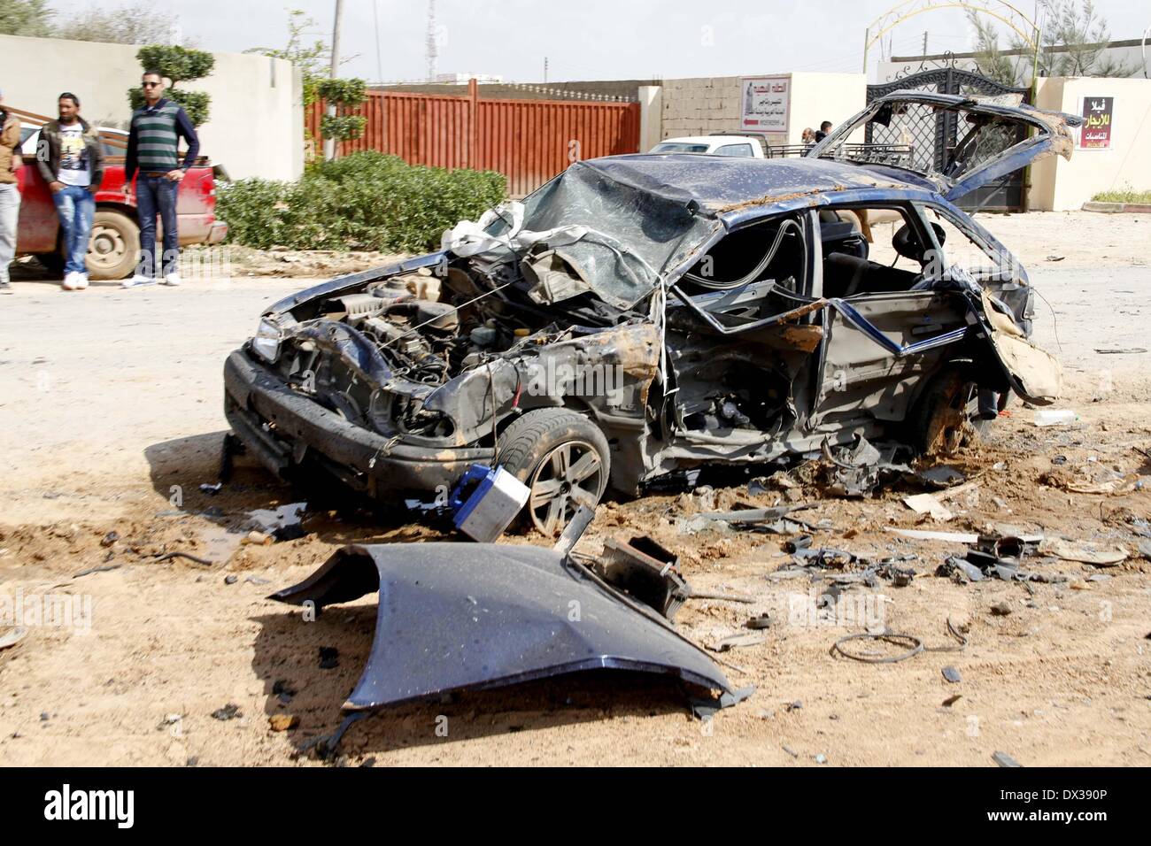 Benghazi, Libya. 17th Mar, 2014. People check a damaged car in Benghazi, Libya, March 17, 2014 ...