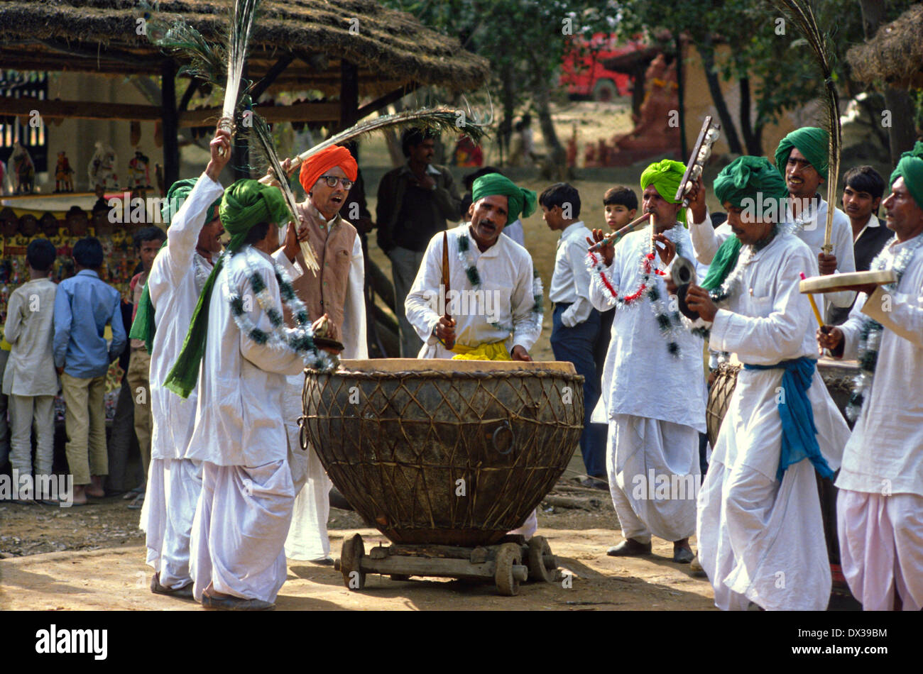 Turbaned Indian men play traditional drums and musical instruments ...