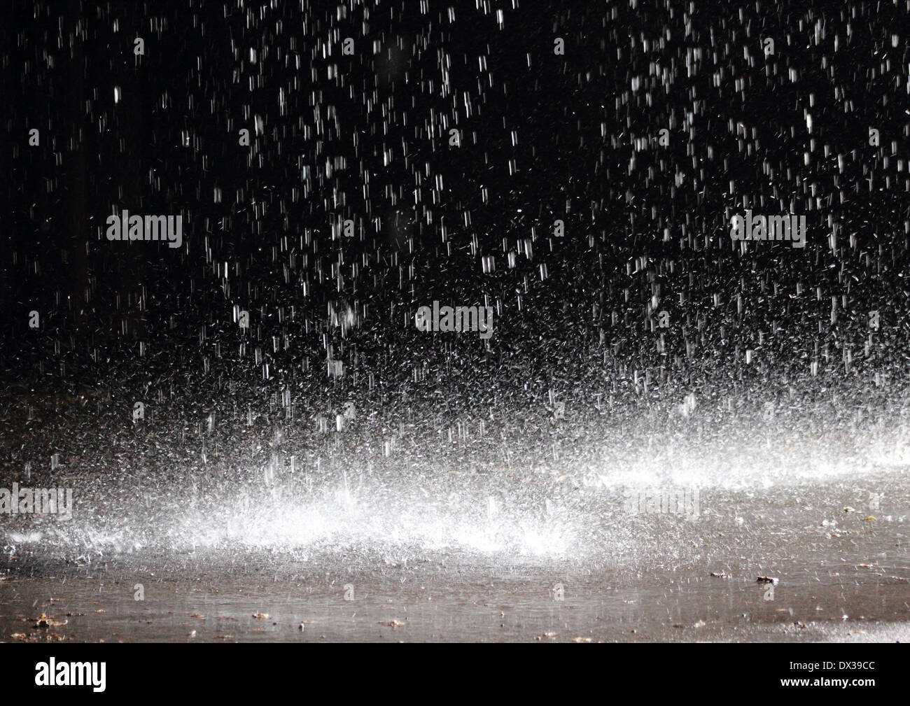 Massive rainfall on asphalt from a broken gutter under a cloudburst ...