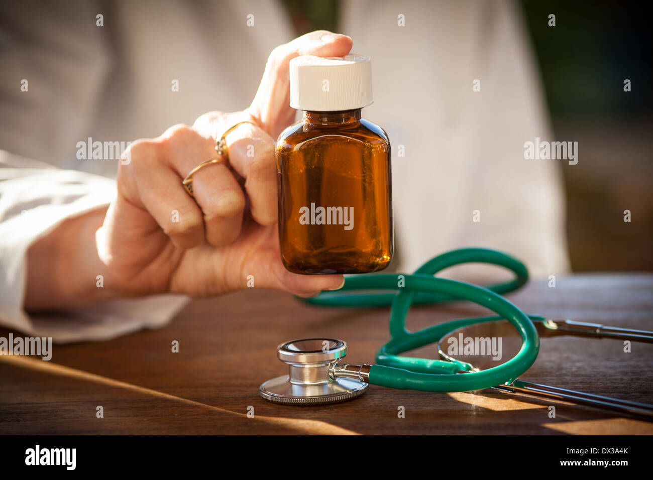 Doctor holding medicine bottle hi-res stock photography and images - Alamy