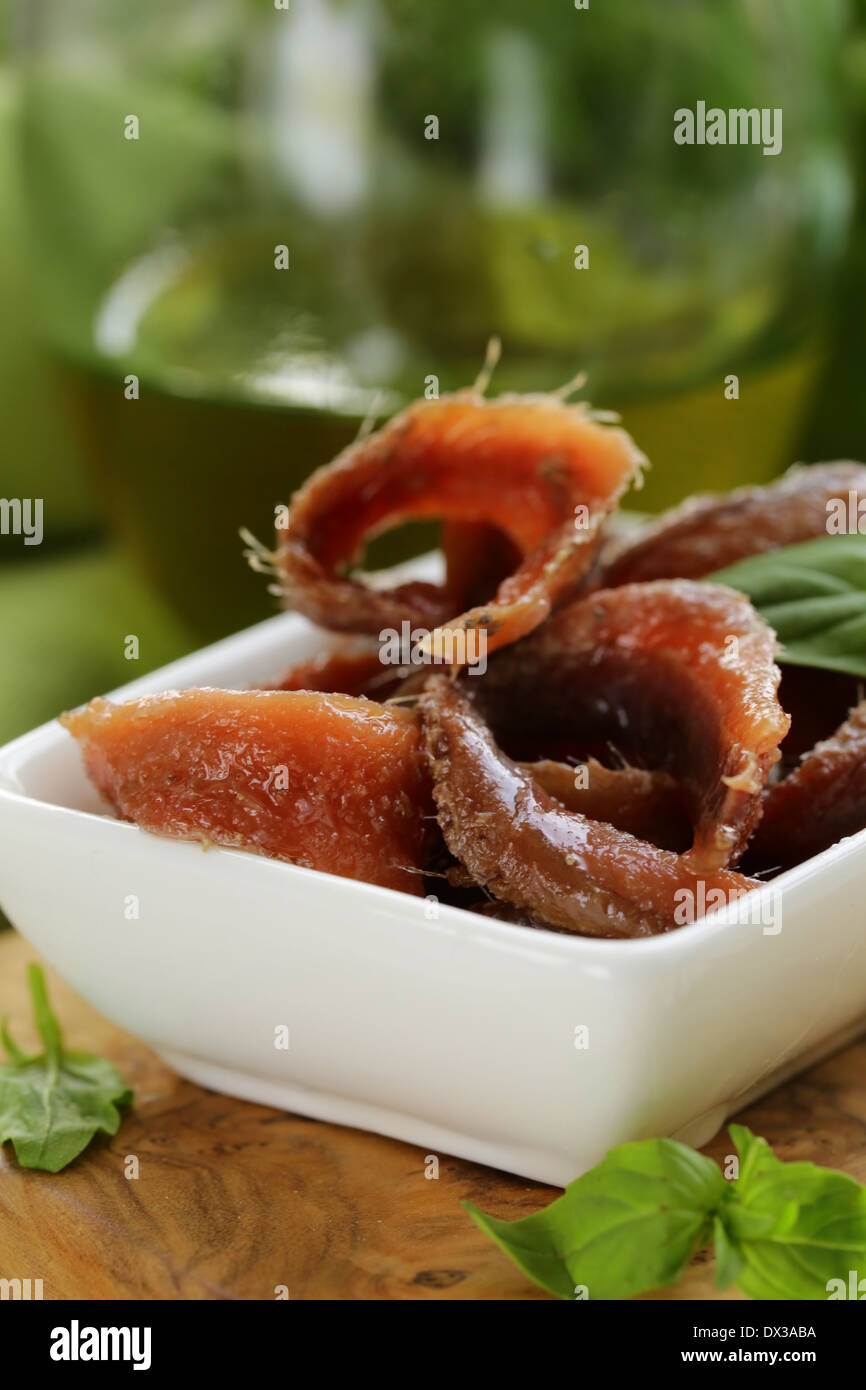 Canned marinated anchovies fillets in a white bowl Stock Photo - Alamy