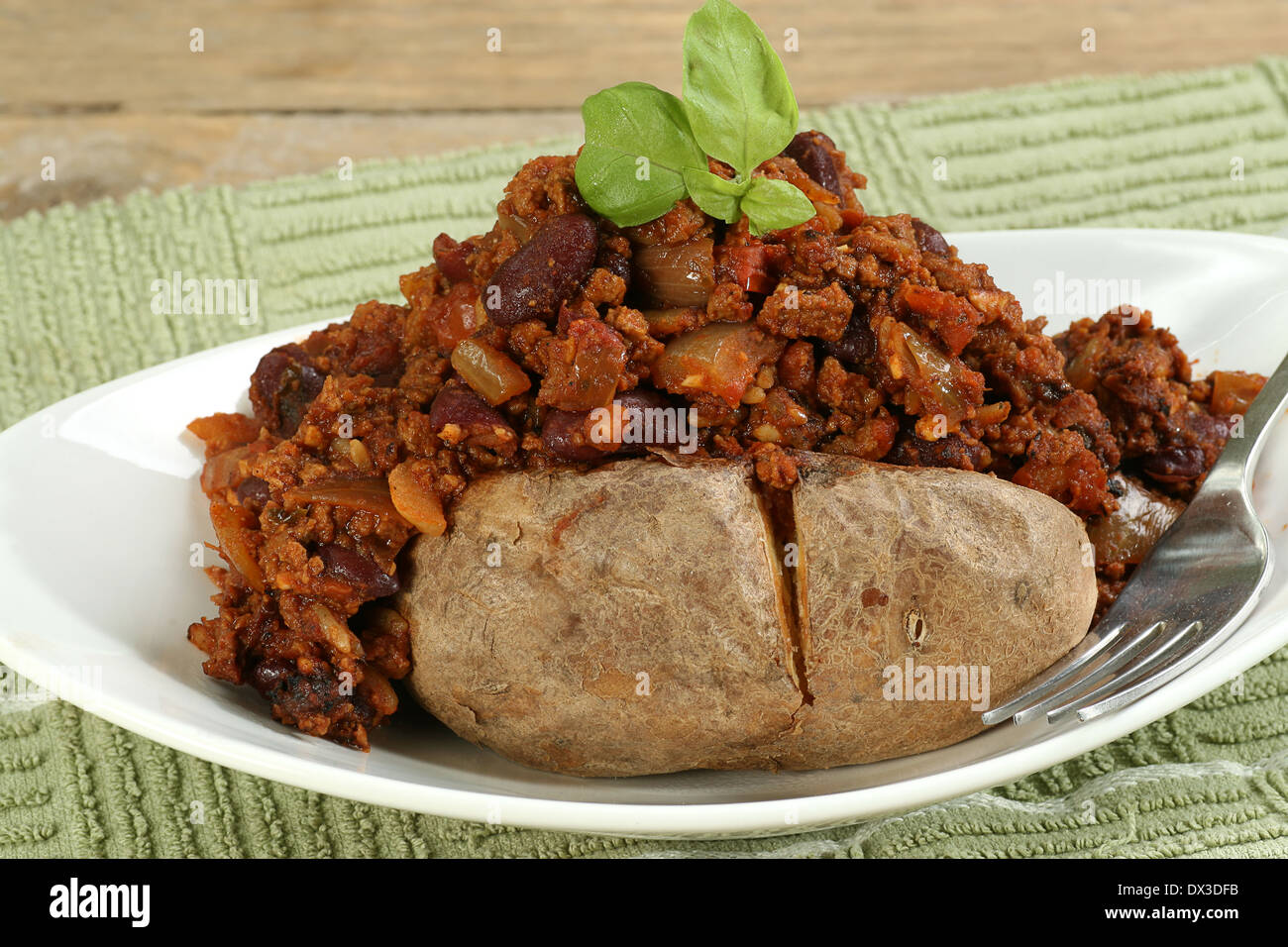 baked jacket potato topped with vegetarian chili Stock Photo - Alamy