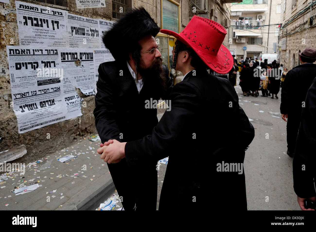 A Hasidic Jew wearing a shtreimel fur hat dancing with a Haredi Jew ...