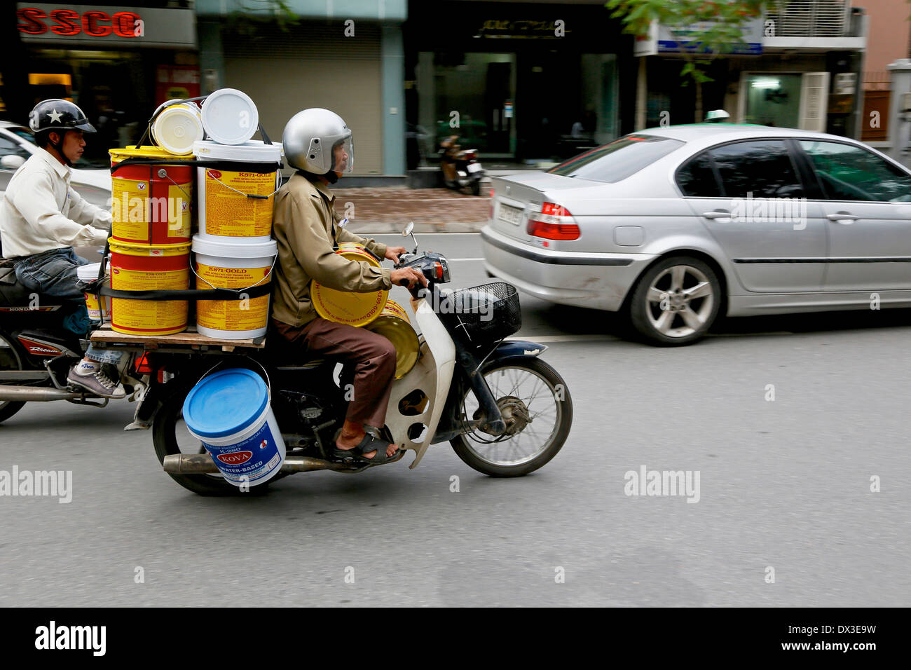 Heavily loaded motorbike carrying goods through Hanoi streets. Hanoi ...