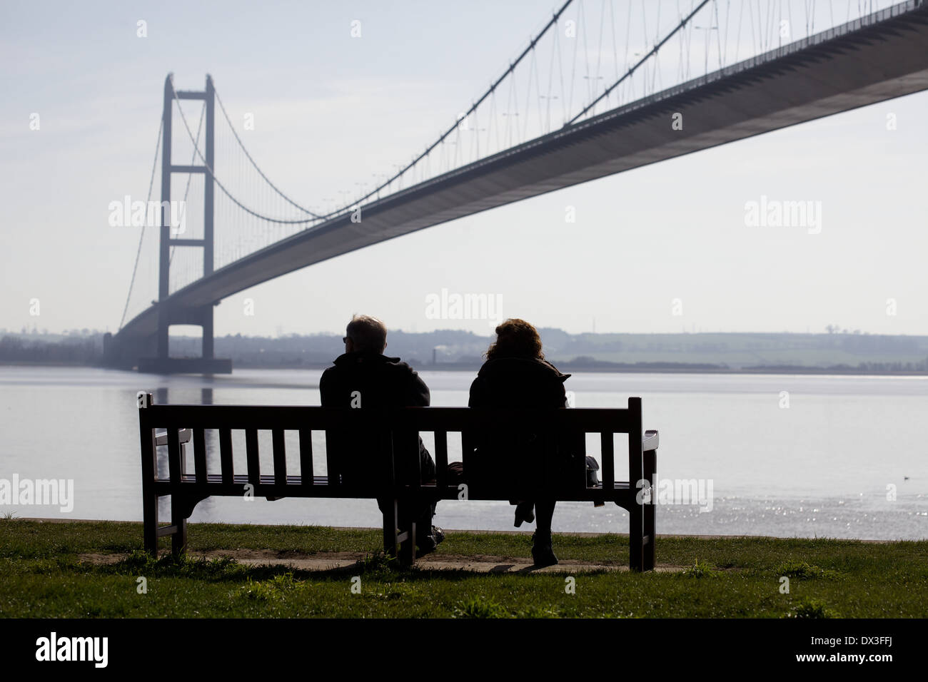 couple on bench watching the Humber Bridge Stock Photo - Alamy