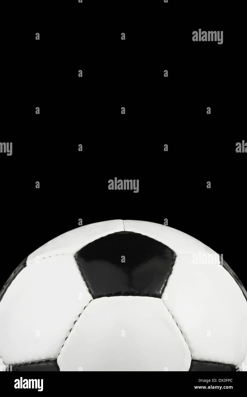 Black and white leather Football on a black background Stock Photo - Alamy