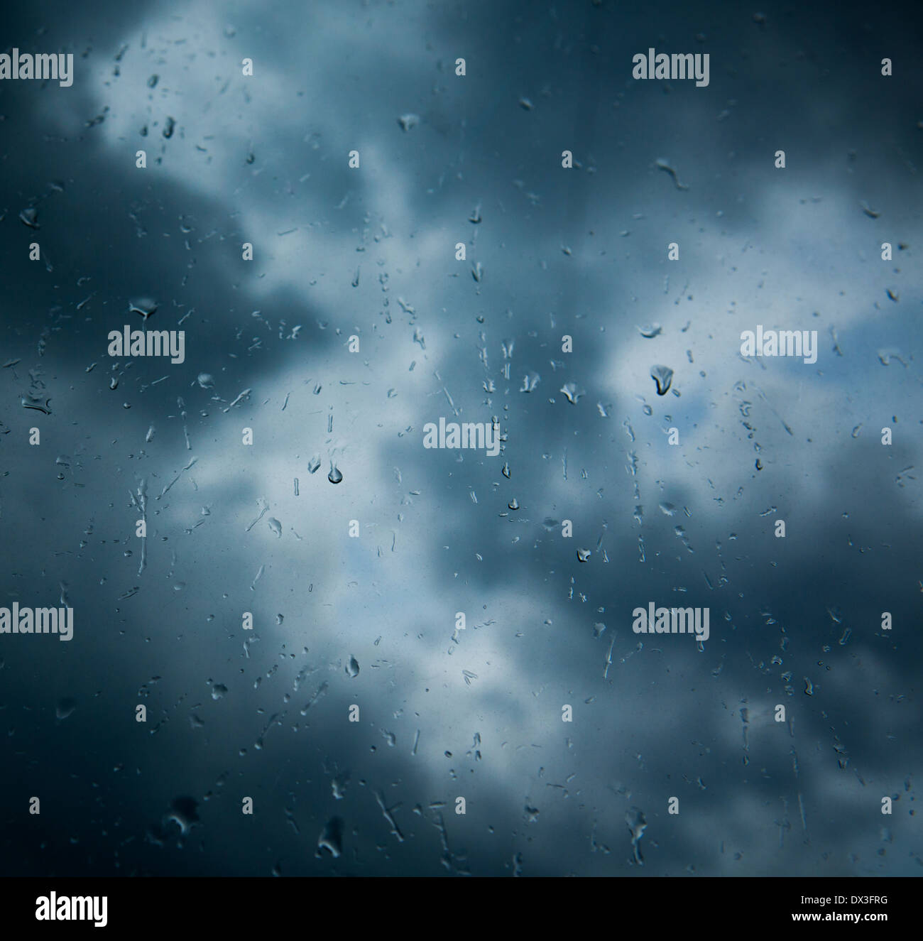 Rain drops on window across clouds Stock Photo - Alamy