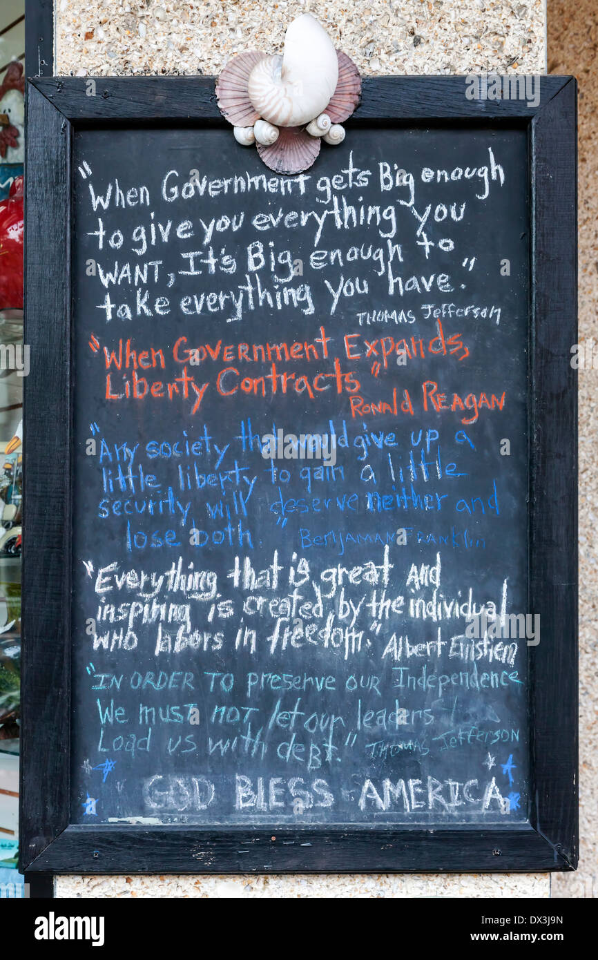 Chalkboard sign posted with various political quotes and "God Bless ...