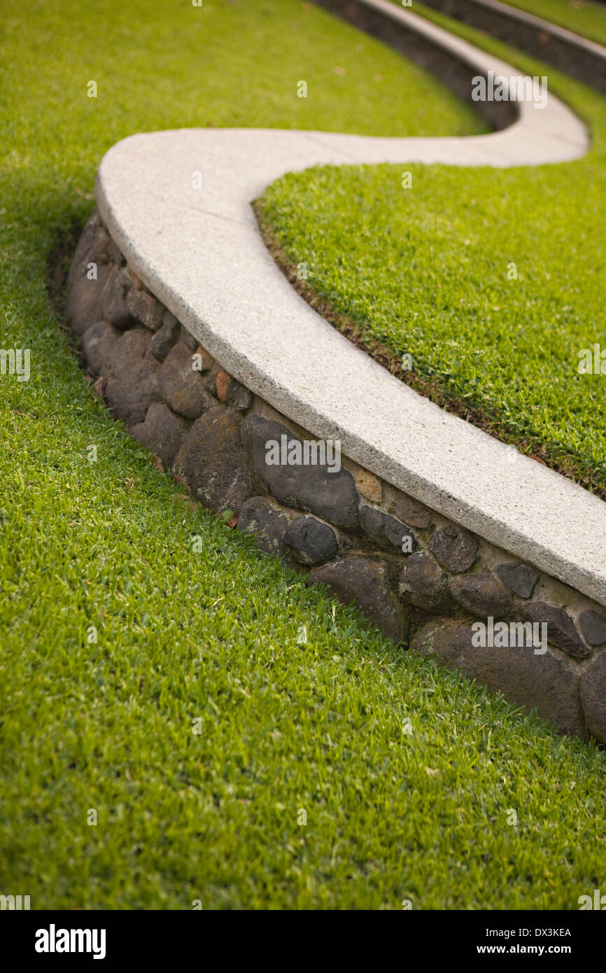 S-shaped ledge along landscaped green grass, tilt Stock Photo - Alamy