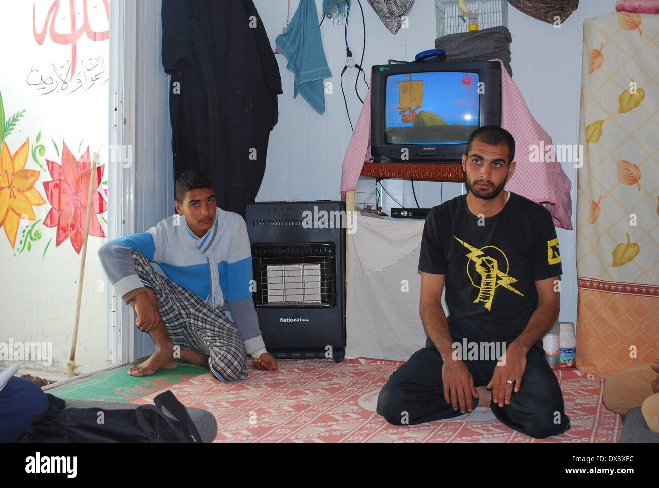 Muhammad (right) together with his wife and brother (left) live in a ...