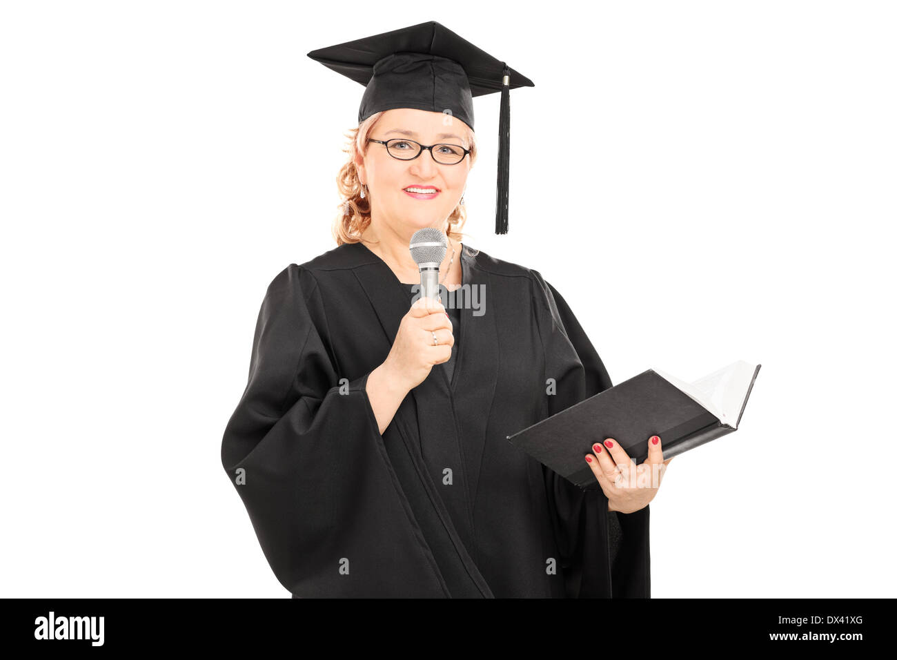 Mature woman in graduation gown reading on a microphone Stock Photo - Alamy